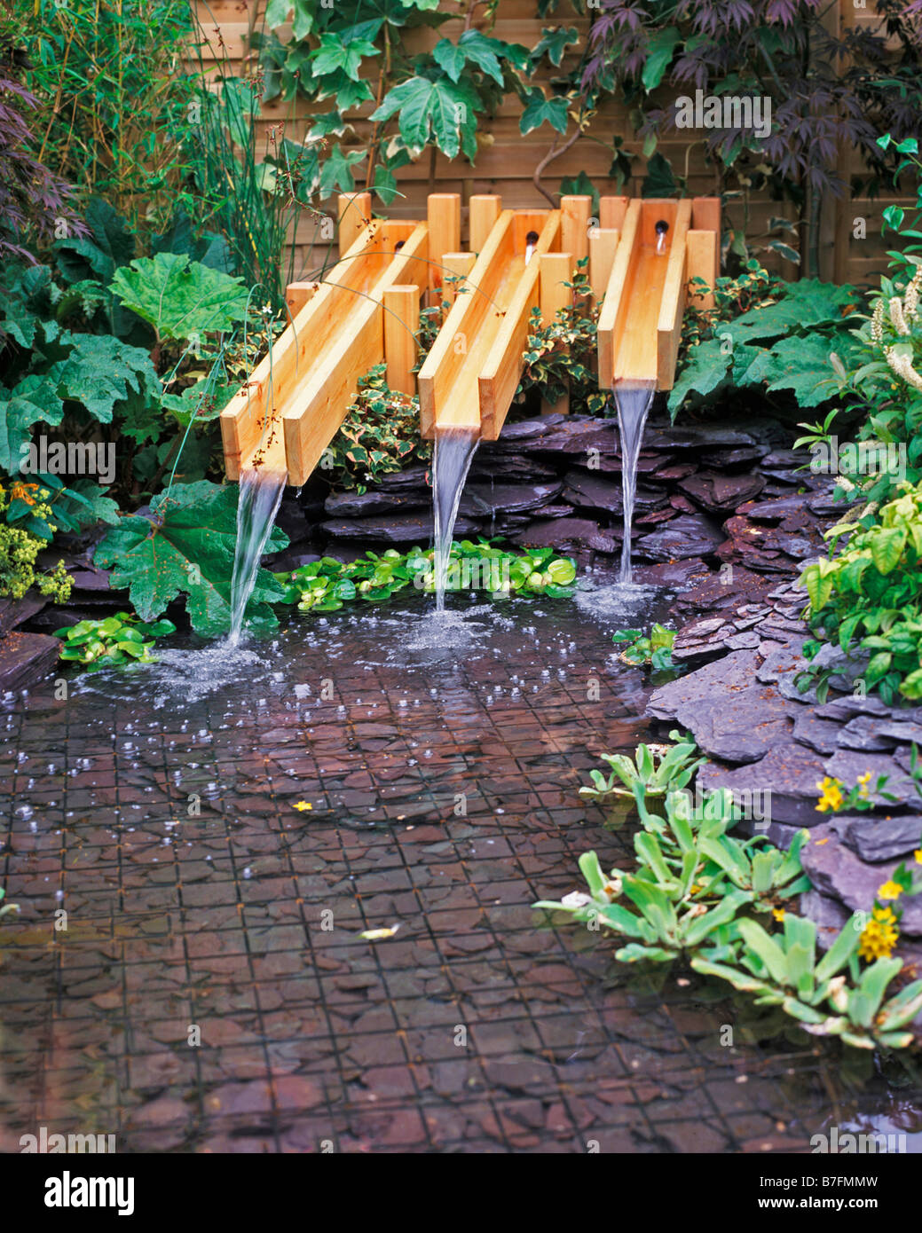 WATER FALL IN WATER FEATURE USING WOODEN TROUGHS Stock Photo - Alamy