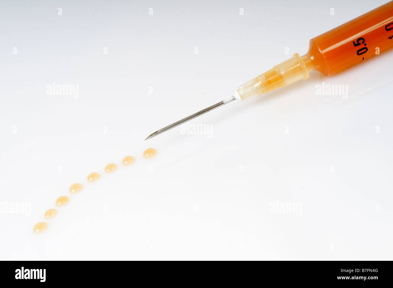Stock photo of a Hyperdermic needle next to drops of liquid from the ...
