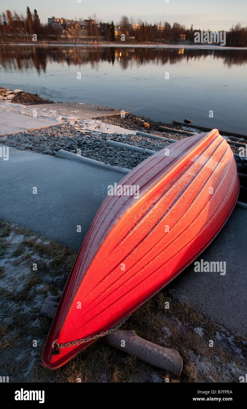 Red fiberglass rowboat / skiff / dinghy , upturned for Winter storage ...