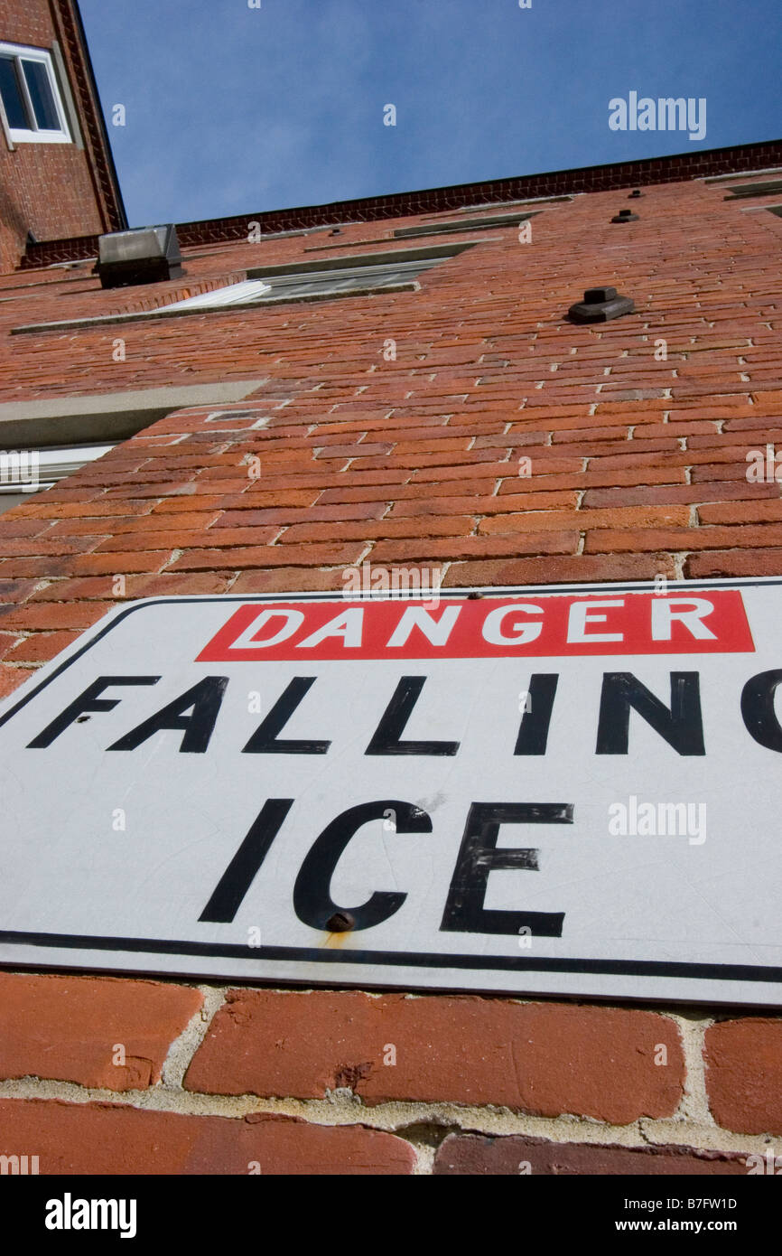 Looking up side of old brick building with Danger Falling Ice sign ...