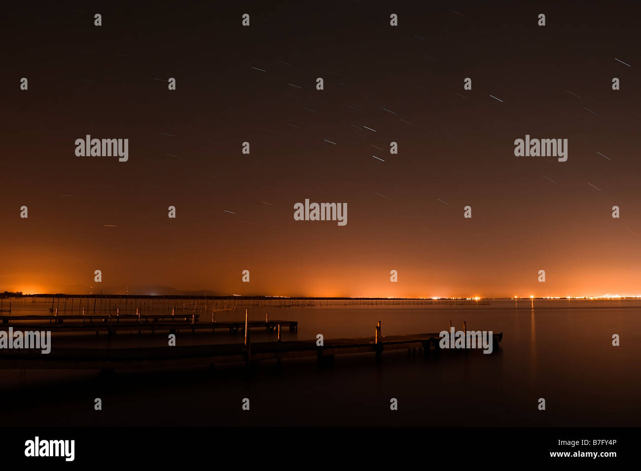 Long exposed stars over lake Stock Photo - Alamy