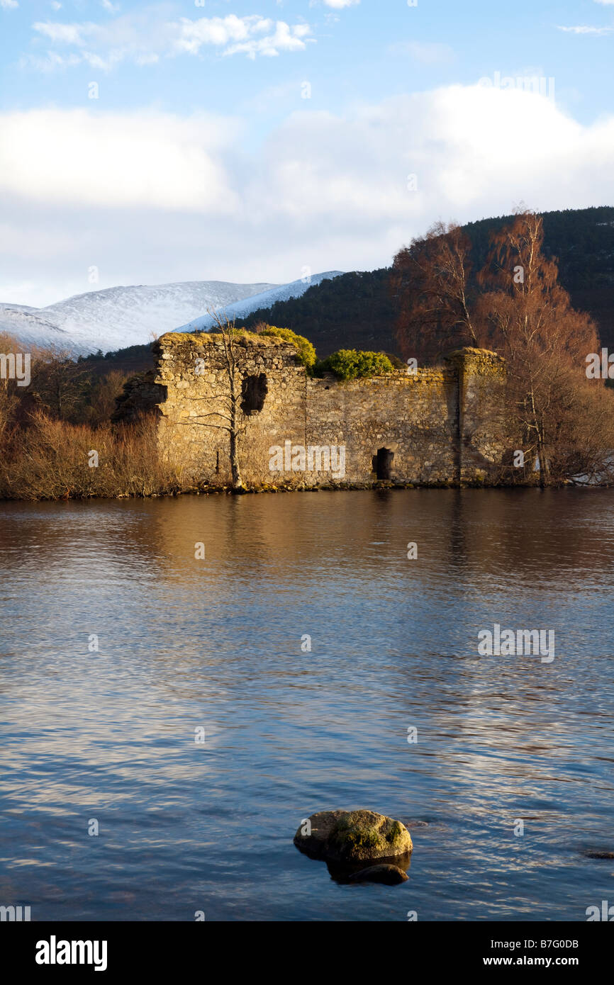 Lochside ruined historic 13th century island castle, forest and hill at ...