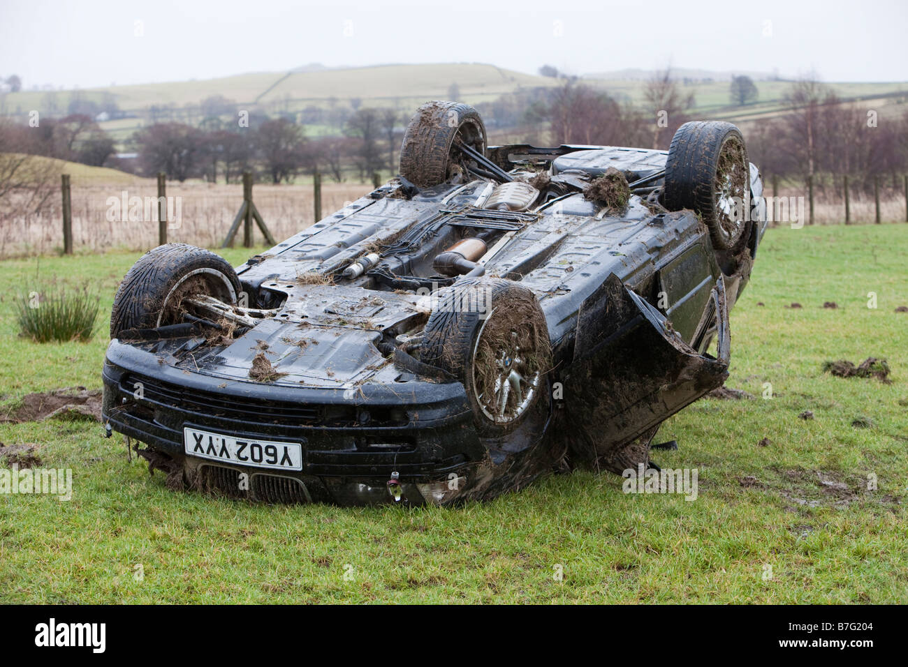 A BMW car crashed on its roof in the middle of a field after leaving ...