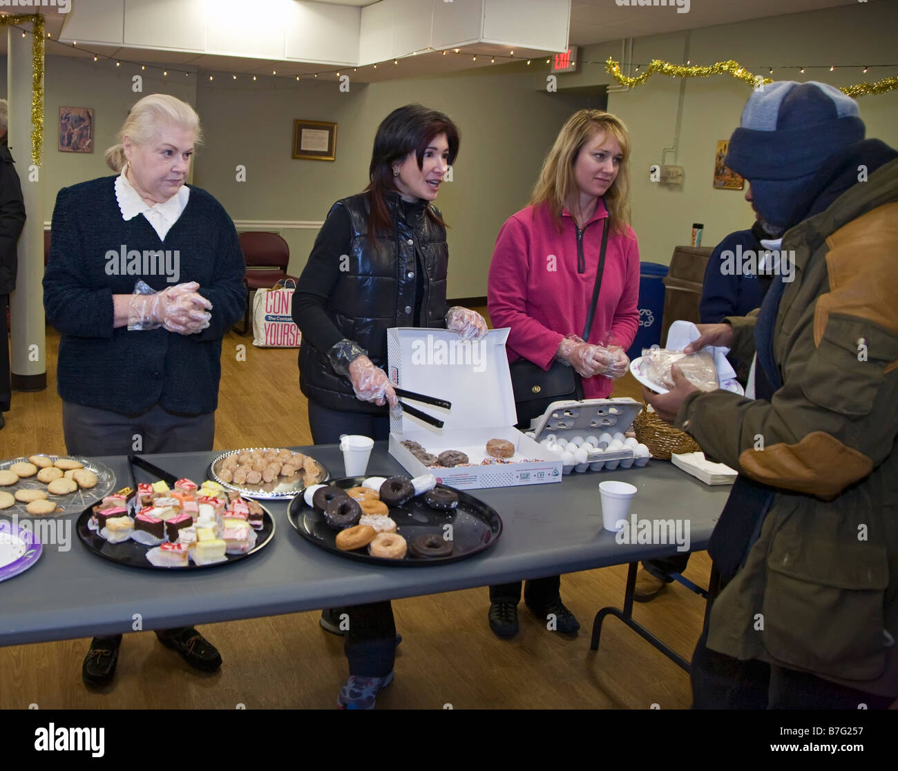 Volunteers Serve Breakfast to Homeless Men Stock Photo - Alamy