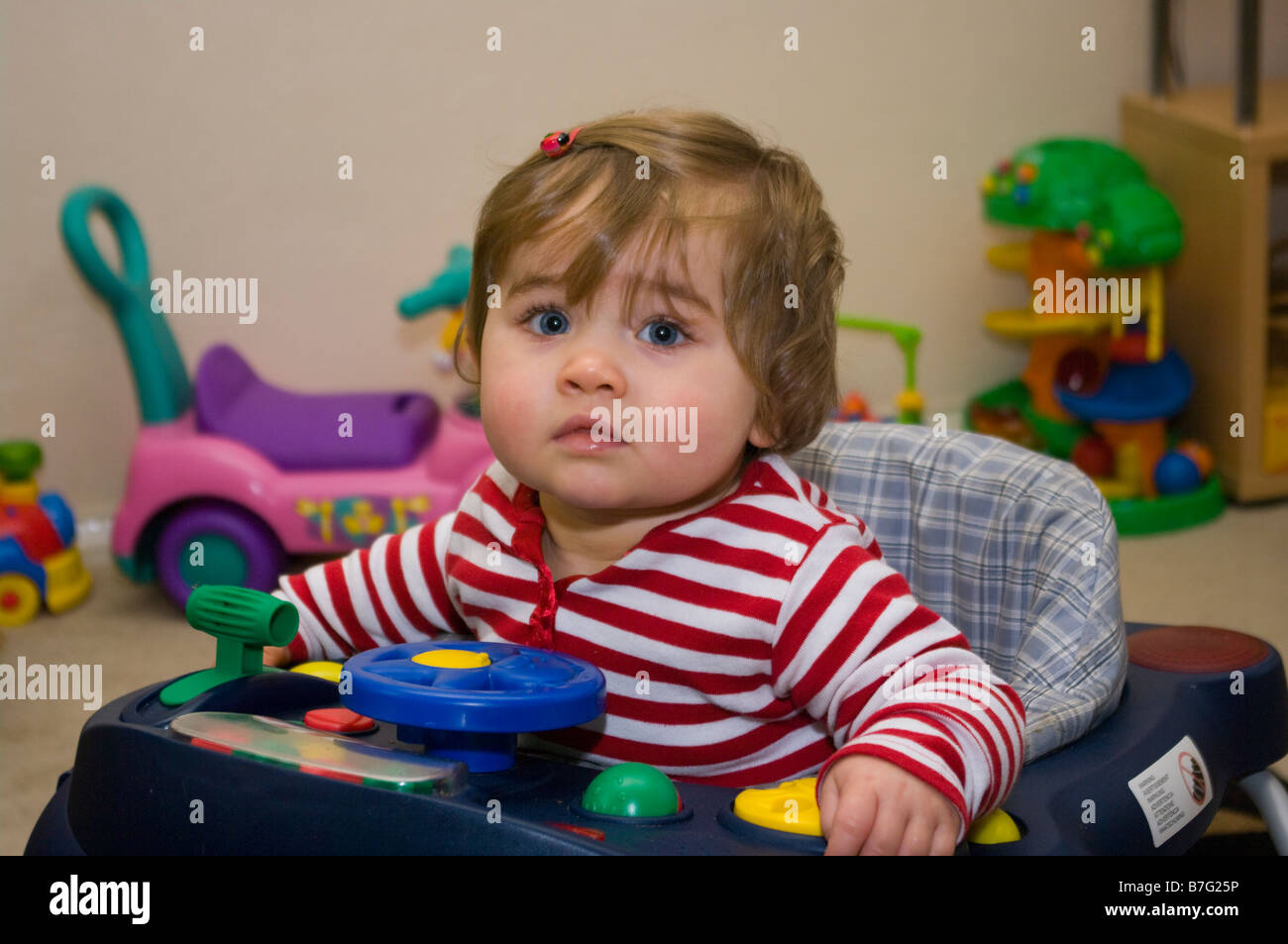 Baby Child Girl Sitting in a Baby Walker Stock Photo - Alamy