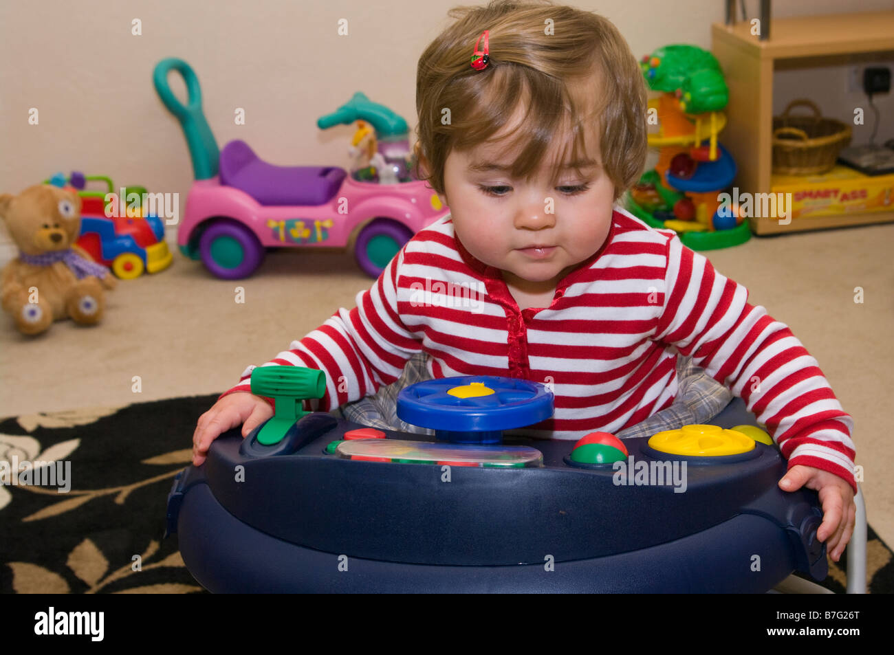 Baby Girl Child Sitting in a Baby Walker Stock Photo - Alamy