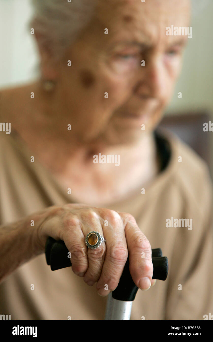 Senior woman holding a cane Stock Photo - Alamy
