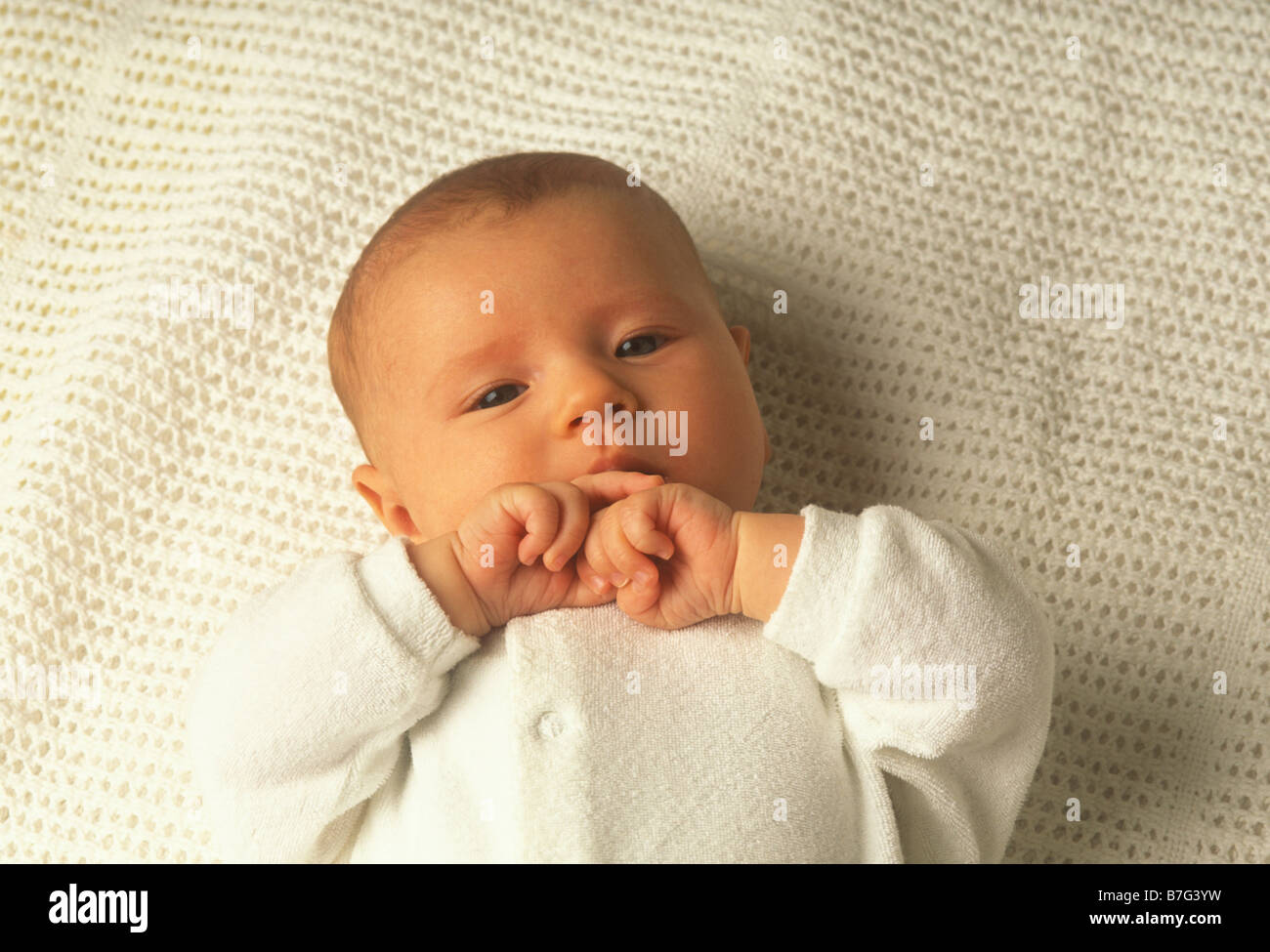 cute baby on her back looking into camera Stock Photo - Alamy