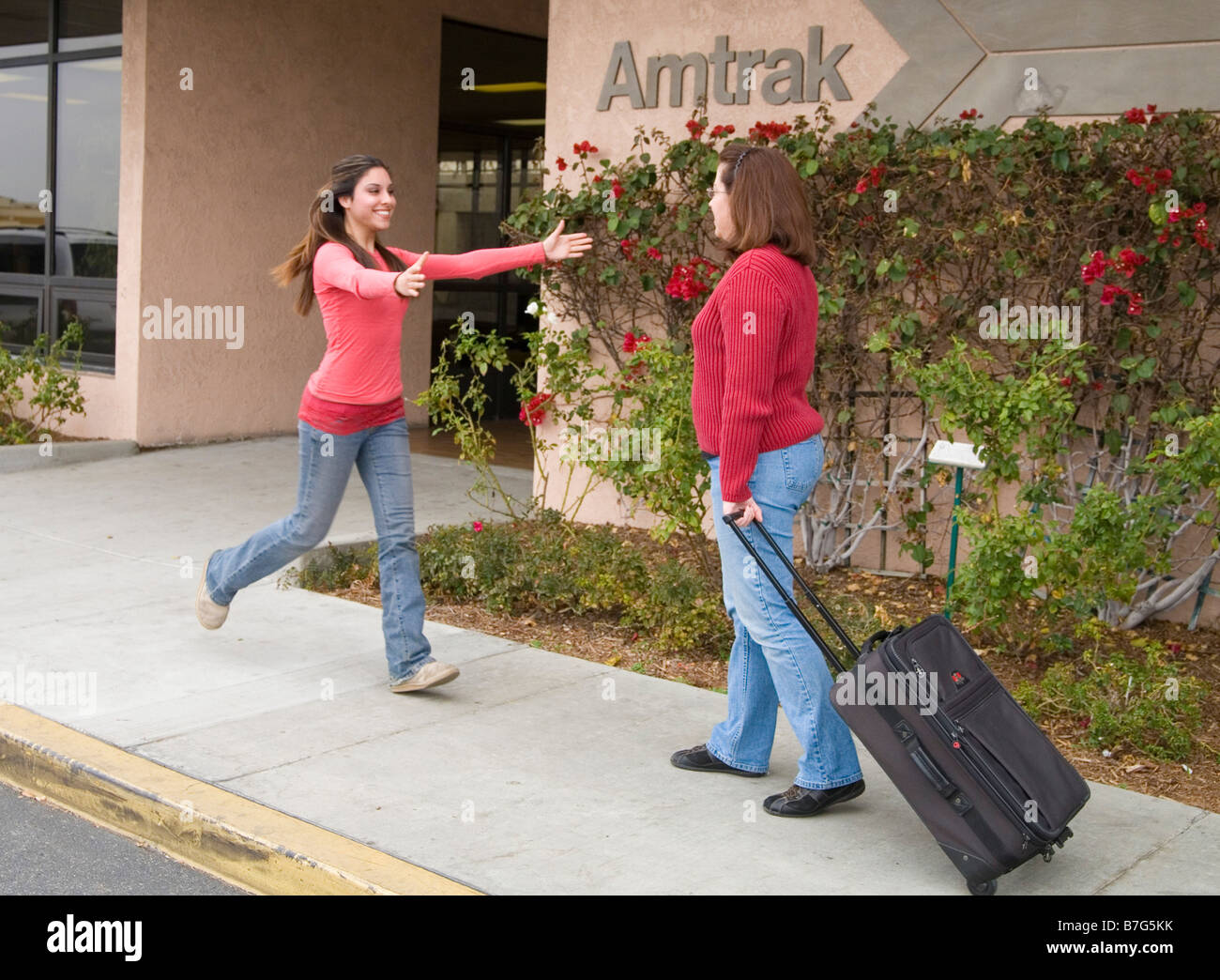 mother daughter travel return come home train greet love welcome hug ...