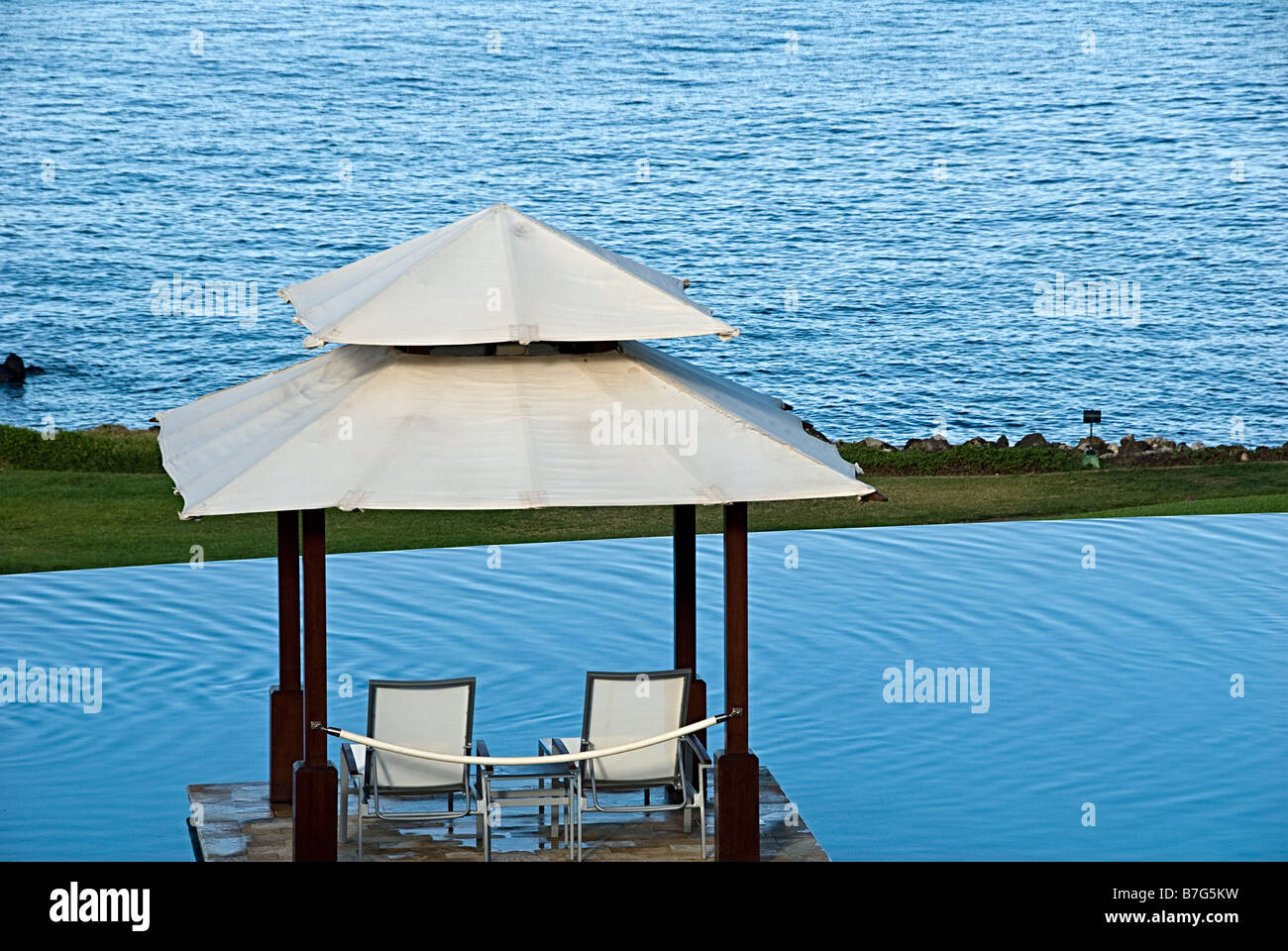 private cabana overlooking infinity pool and blue water of pacific ...
