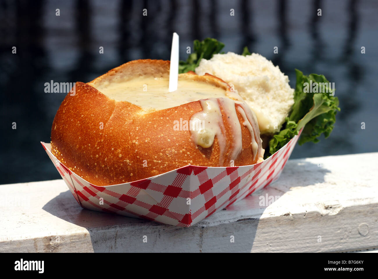 Clam chowder in a sourdough bread bowl on a wooden fishing dock Stock ...