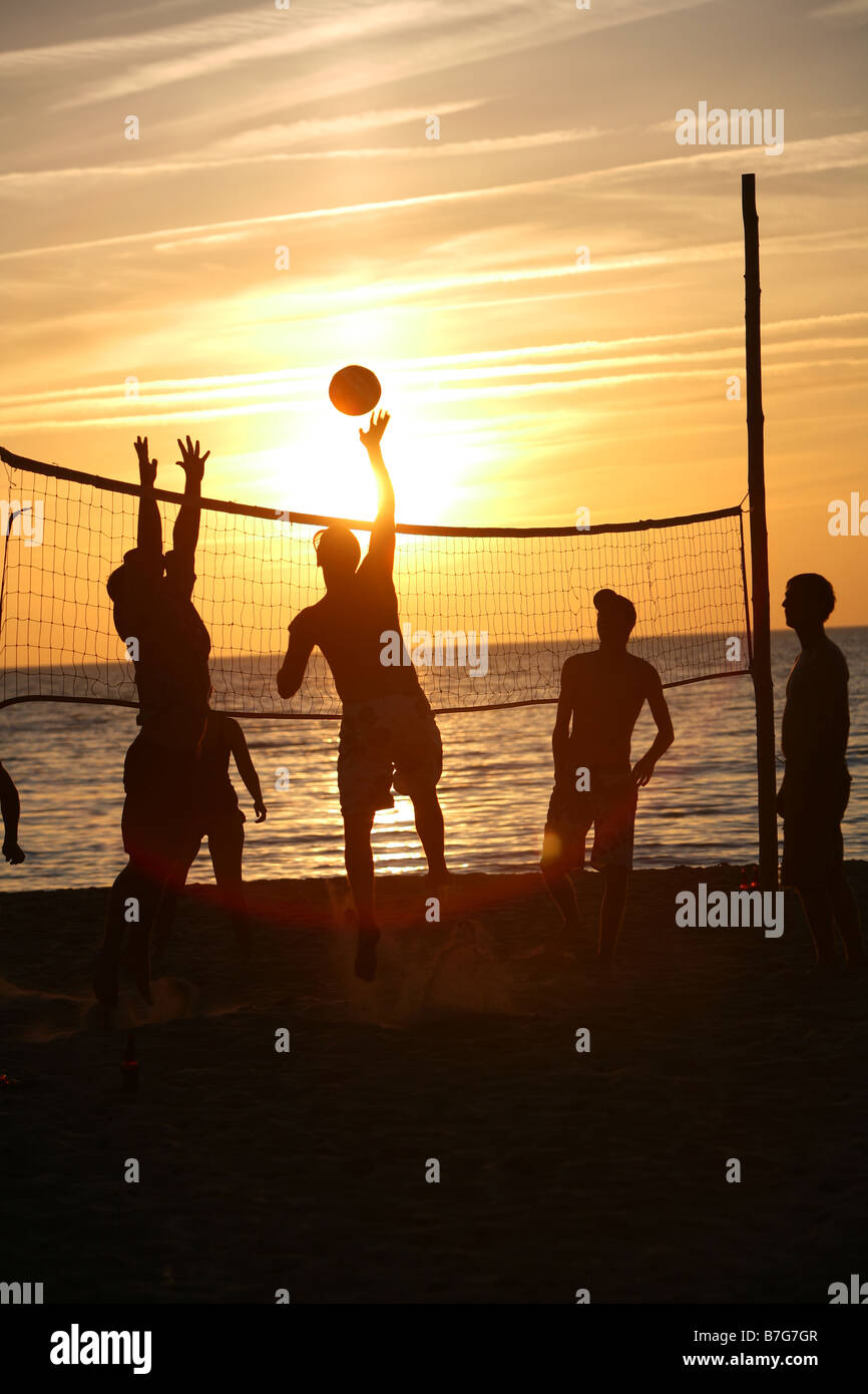 beach volleyball game at sunset Stock Photo - Alamy