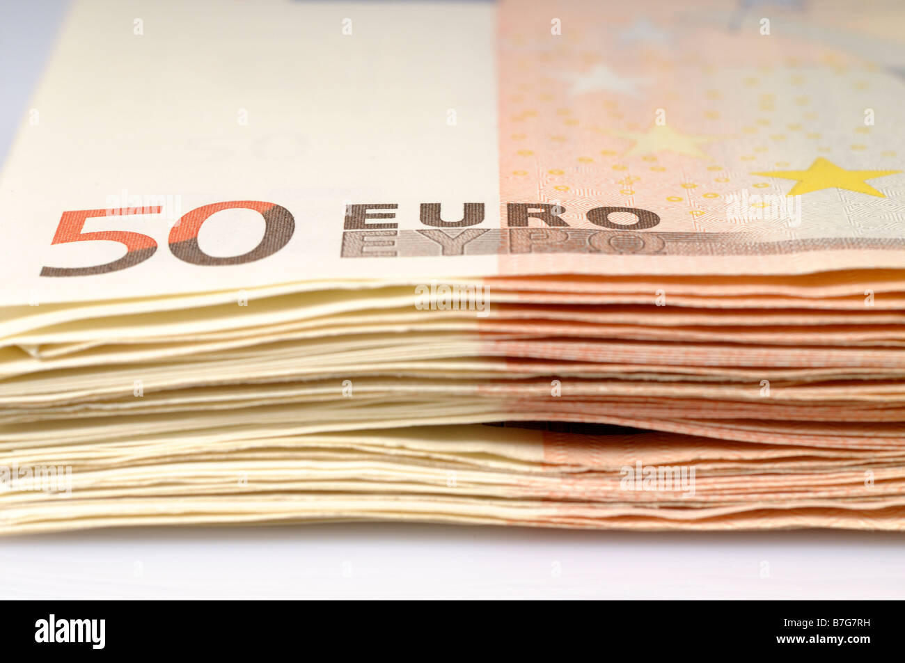 Stock photo of a pile of 50 Euro notes shot against a white background ...