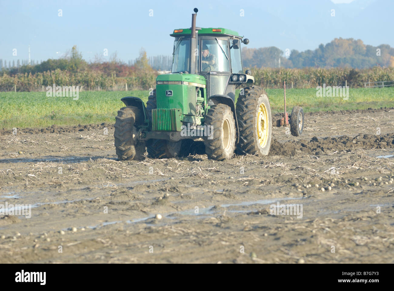 Farmer plowing his field With a Tractor Stock Photo - Alamy