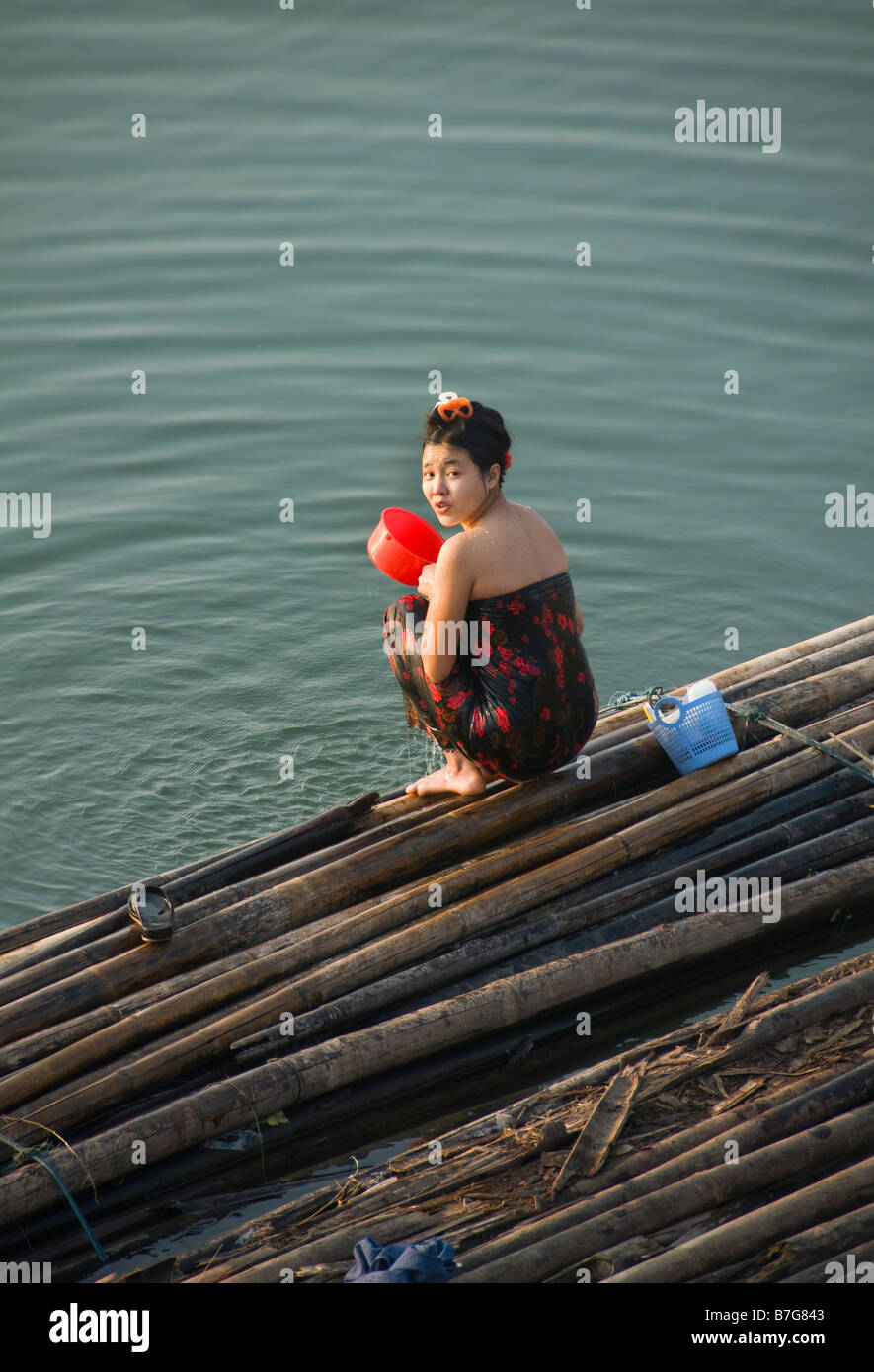Mon woman bathing on a raft in Sangkhlaburi Thailand Stock Photo - Alamy