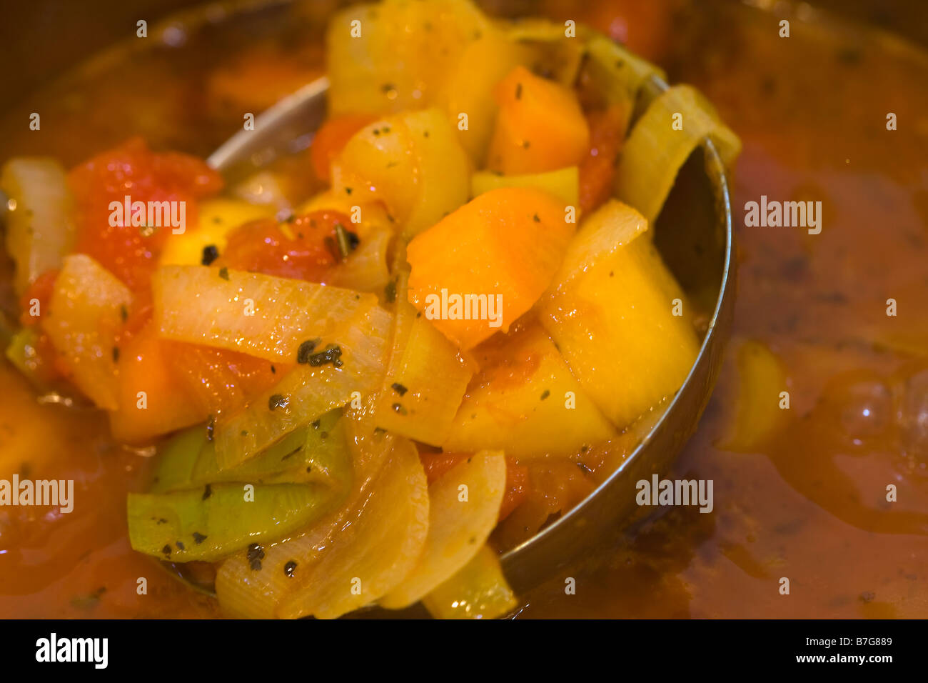 Close-up of vegetable soup cooking in a pan in ladle Stock Photo - Alamy