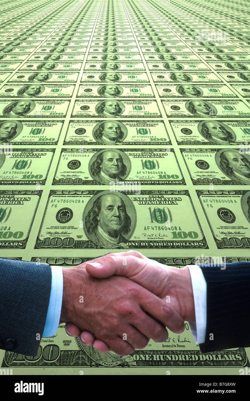 closeup businessmen shaking hands with money background Stock Photo - Alamy