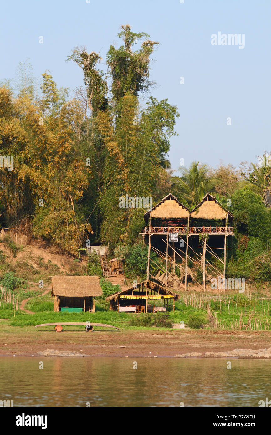 Two huts on stilts at river bank Stock Photo - Alamy