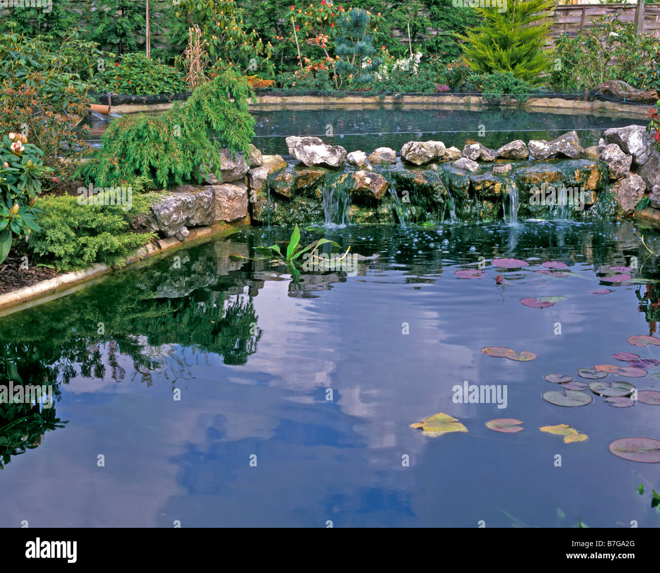 POND WITH WIDE LOW WATERFALL Stock Photo - Alamy