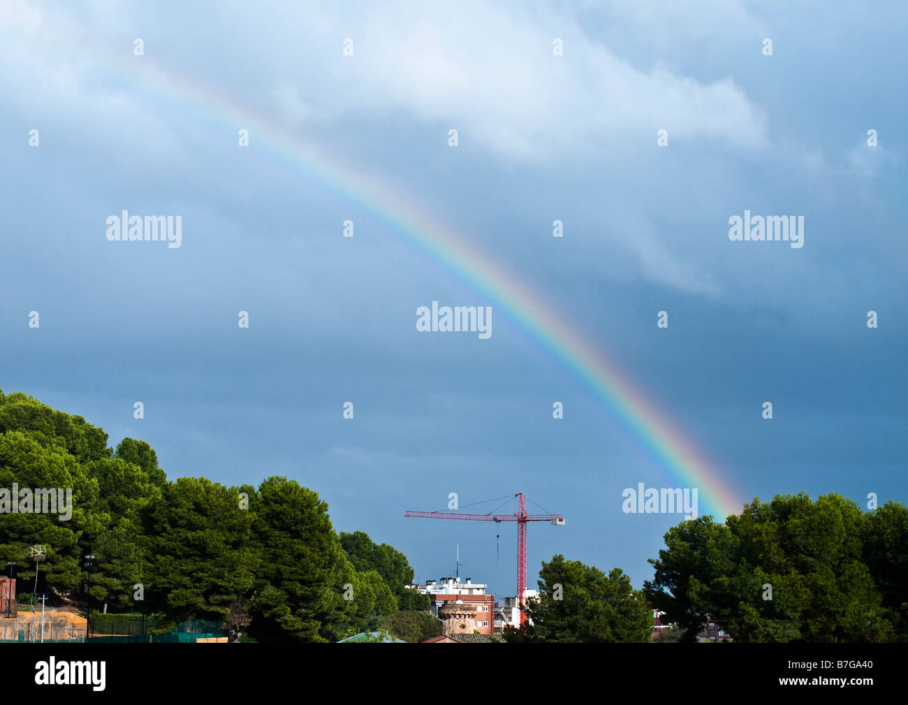 Rainbow over construction building Stock Photo - Alamy