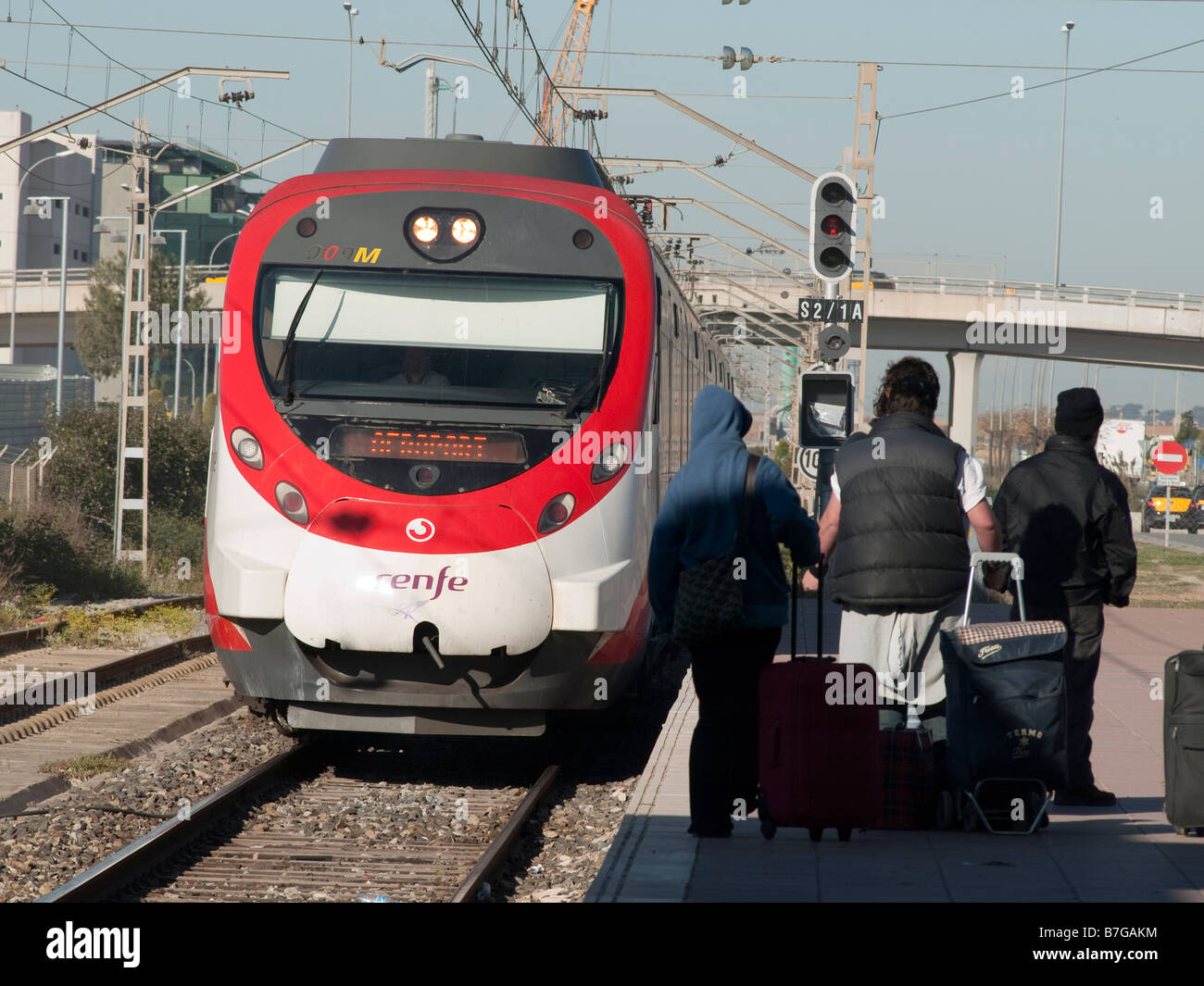 Train entering a train station and people with luggage Stock Photo - Alamy