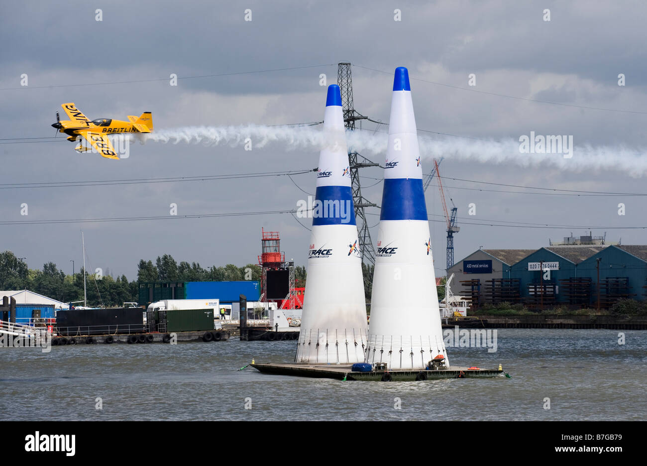 Light race plane flying through air filled pylons at Red Bull air race ...