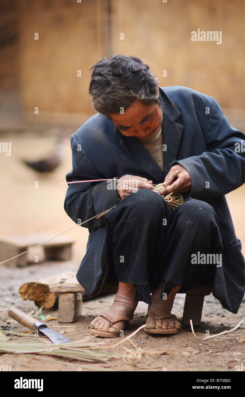 Laos village man basket weaving in suit Stock Photo - Alamy
