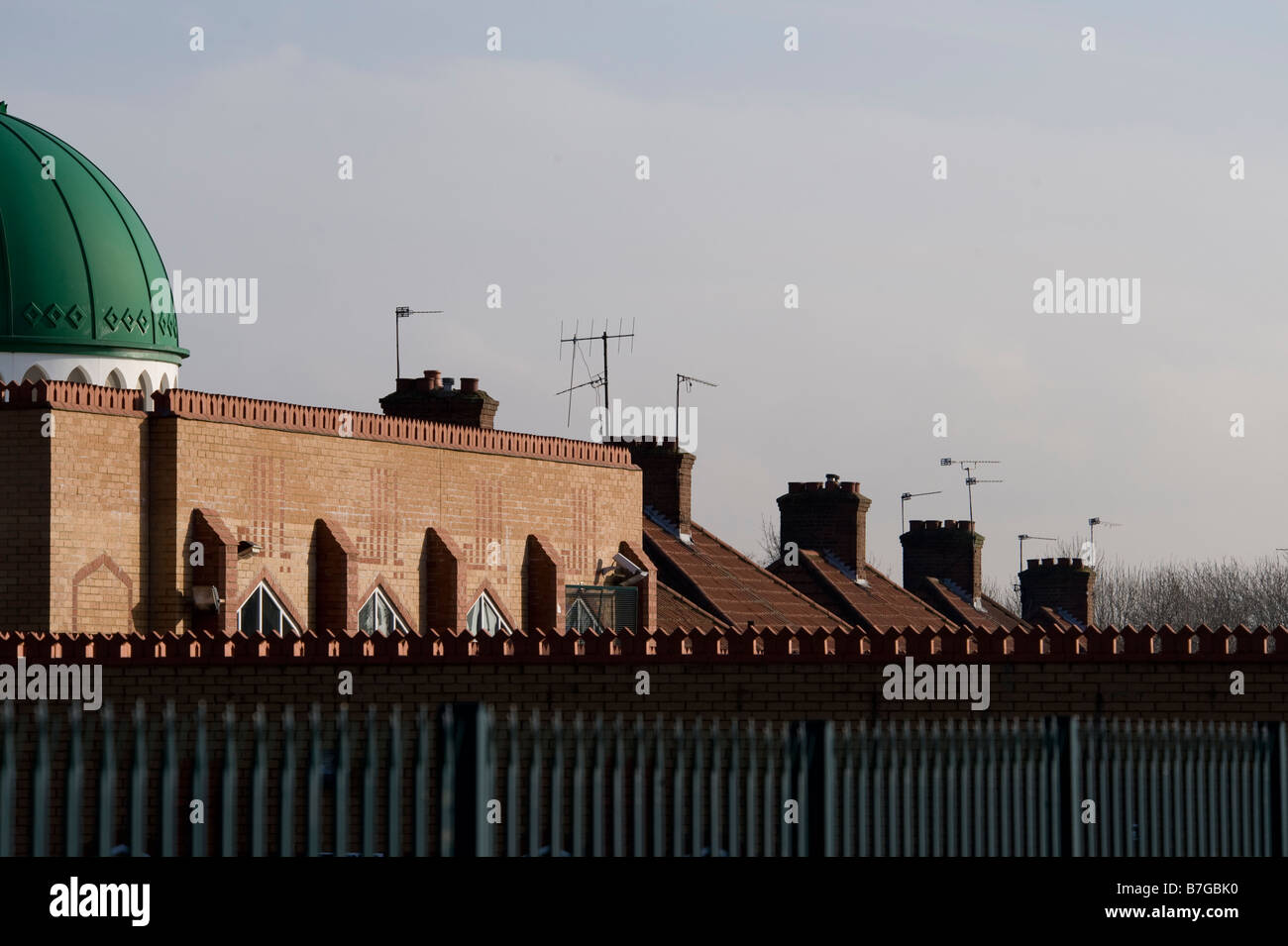 North Watford mosque in winter sunlight with typical English rooftops ...