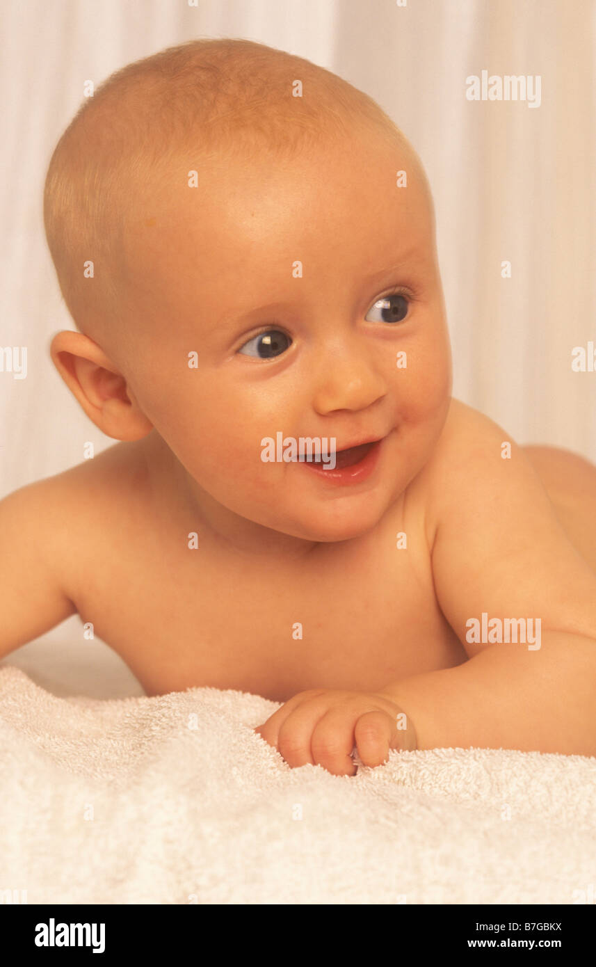 cute baby smiling and pushing himself up Stock Photo - Alamy