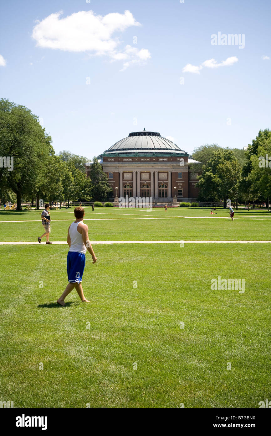 students playing frisbee on the lawn of the campus of University of ...
