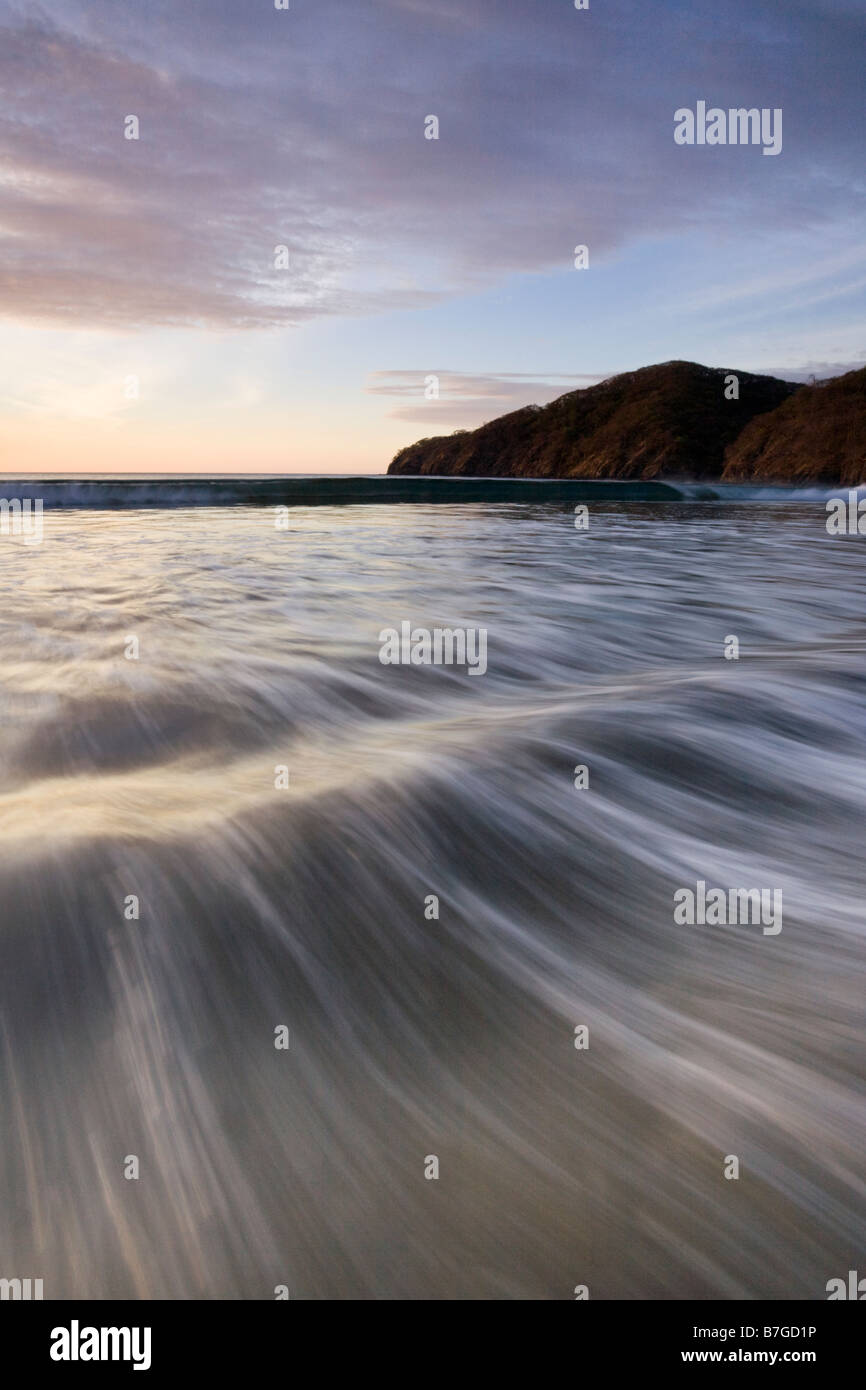 Waves rushing onto the volcanic shore of Playas del Coco, Costa Rica ...