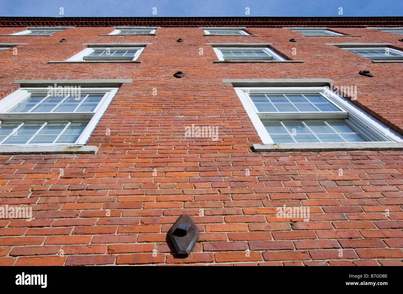 Looking up side of old brick building with windows in Claremont, New ...