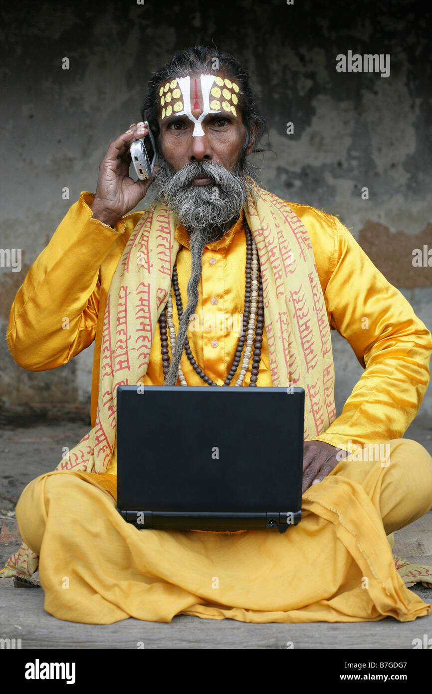“Sadhu using a mobile phone and lap top” Stock Photo - Alamy