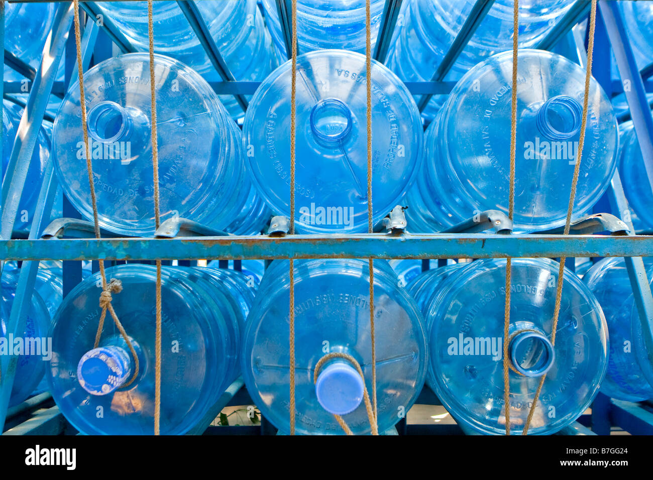 Rows of filled and empty filtered water jugs siting on the back of a ...