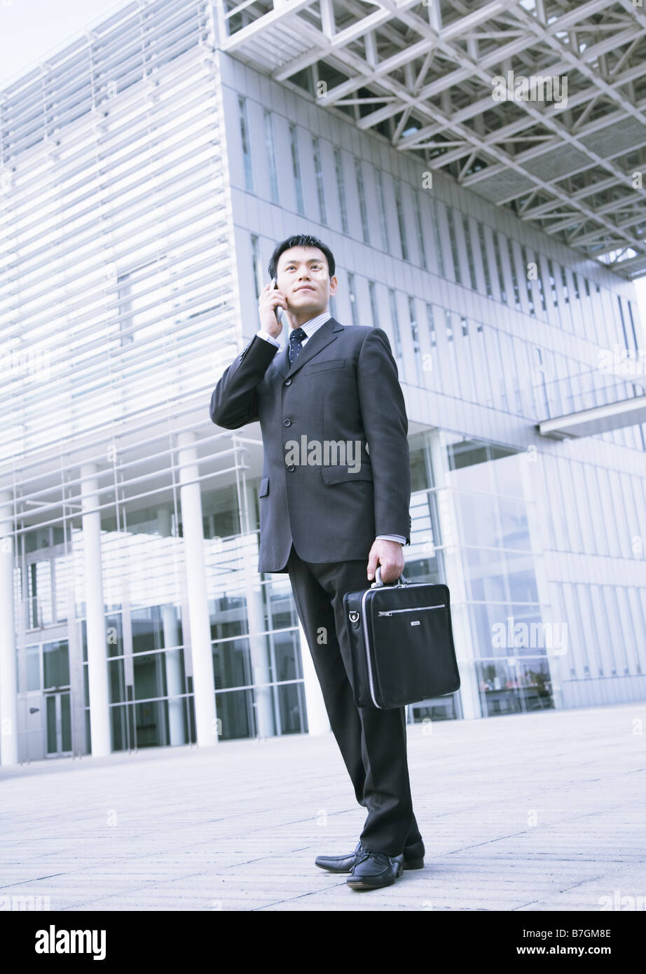 Asian man exiting building hi-res stock photography and images - Alamy