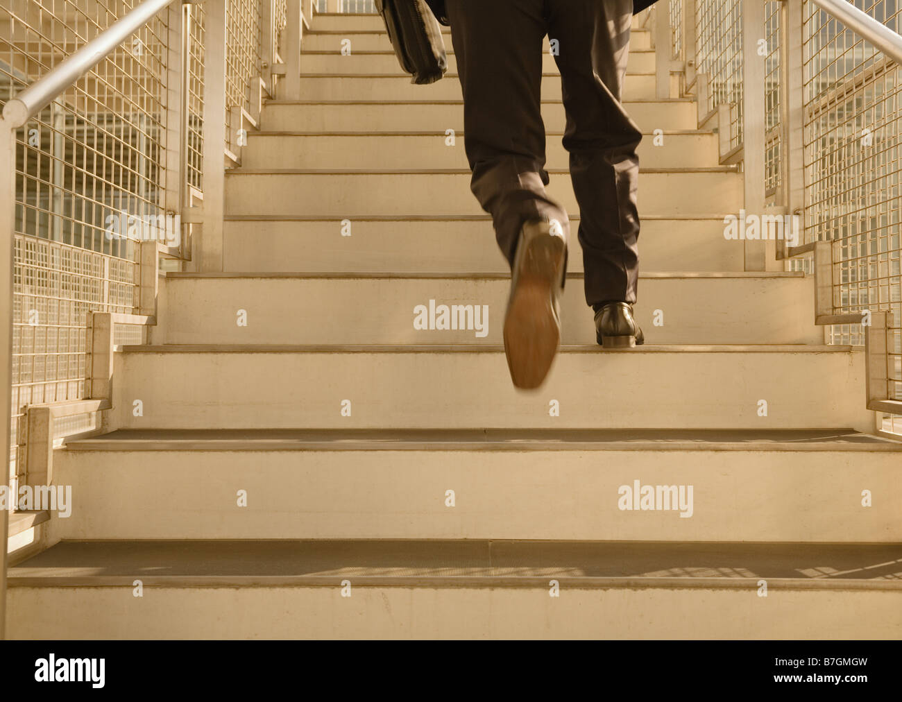 Businessman running up stairs Stock Photo - Alamy