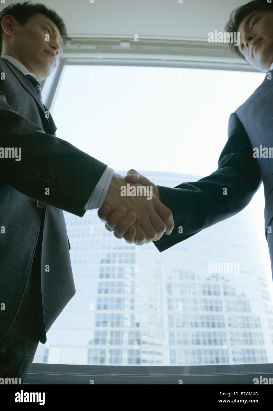 Businessmen shaking hands Stock Photo - Alamy