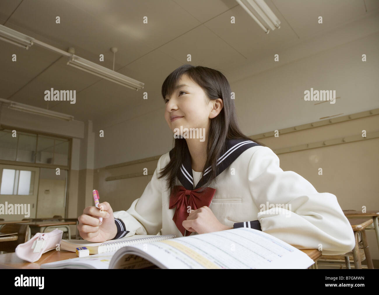 Student taking note in classroom Stock Photo - Alamy