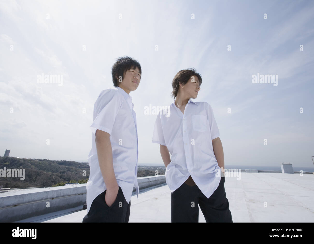 Boys in school uniform standing on rooftop Stock Photo - Alamy