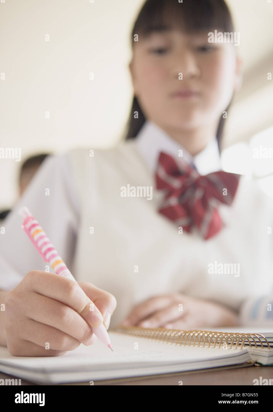 Student taking notes in classroom Stock Photo - Alamy