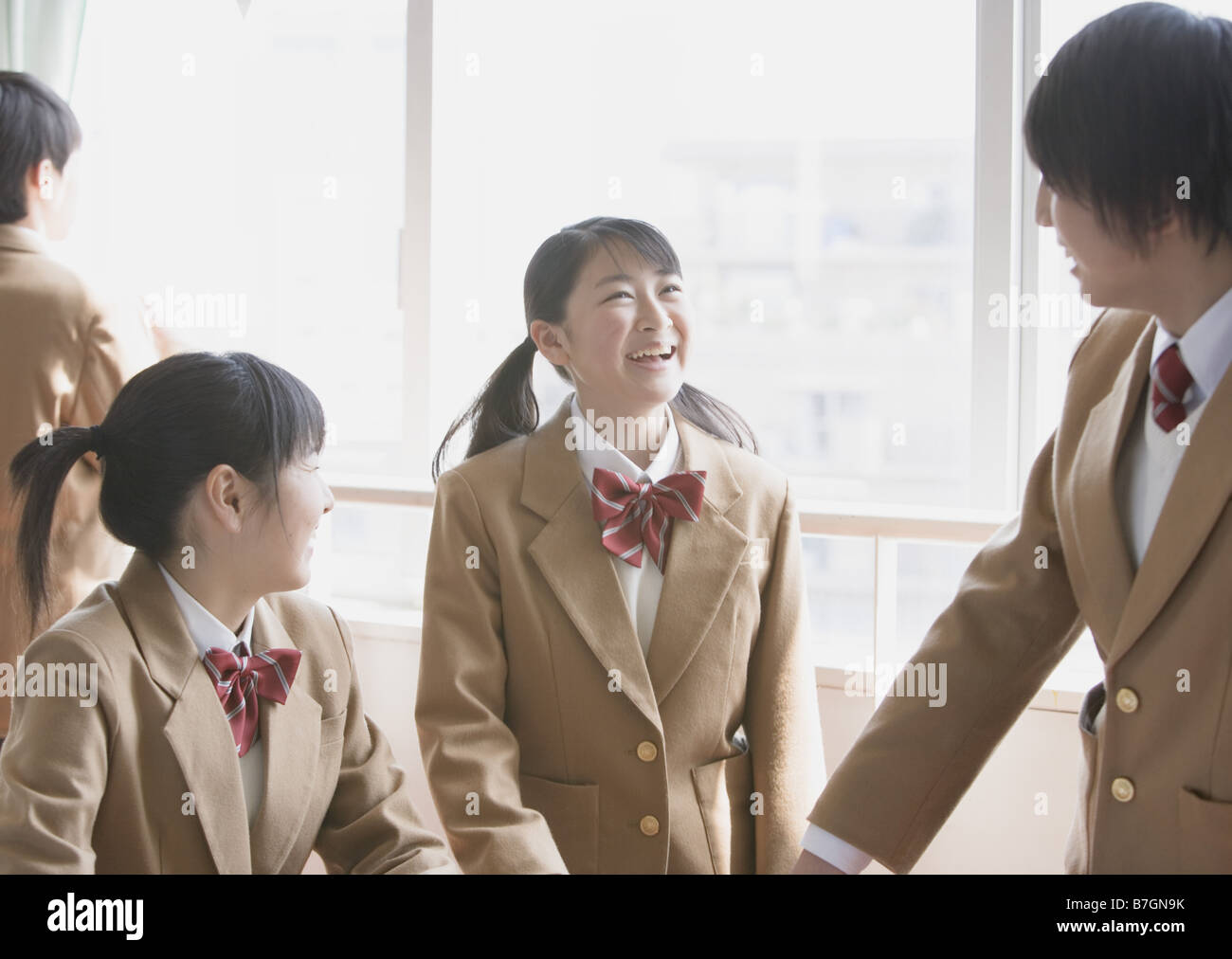 Teenagers talking in classroom Stock Photo - Alamy