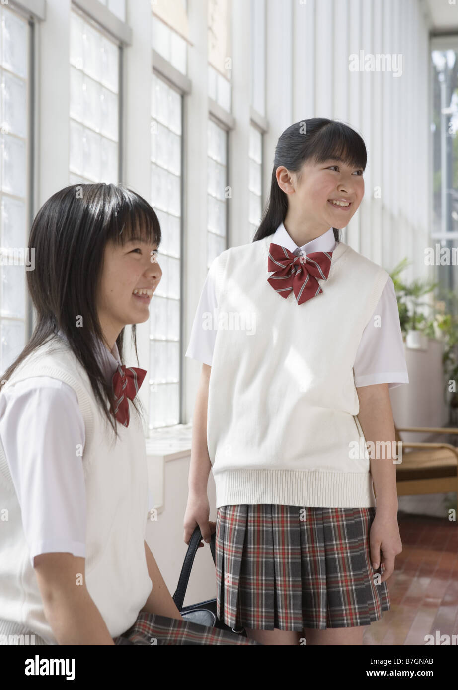 Teenagers talking by window Stock Photo - Alamy