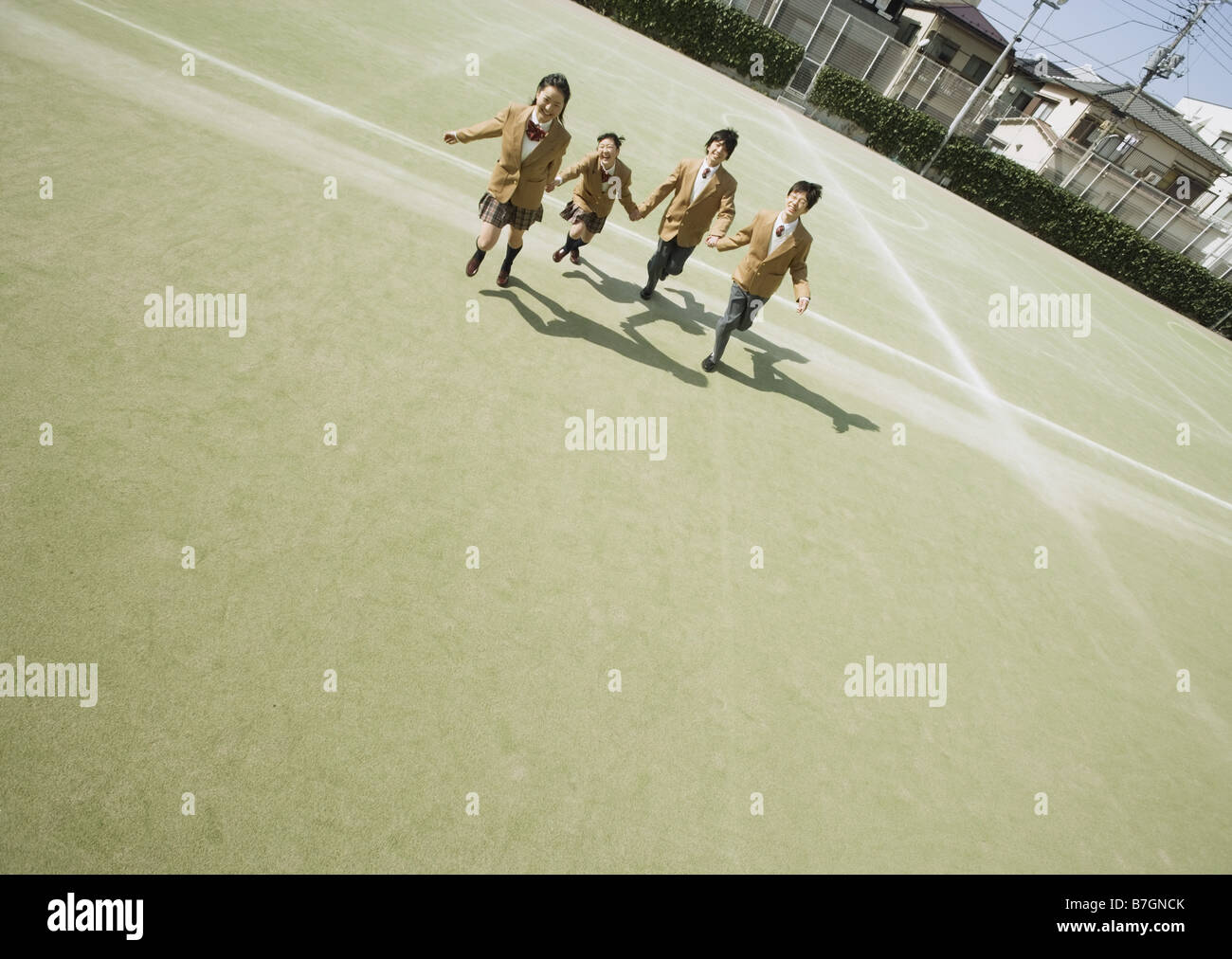 Group of students running in athletic field Stock Photo - Alamy