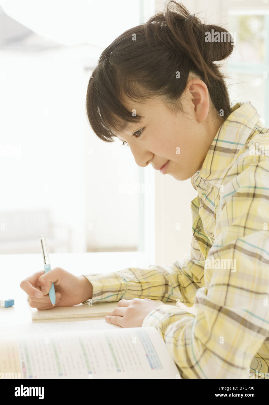 Girl studying at the desk Stock Photo - Alamy