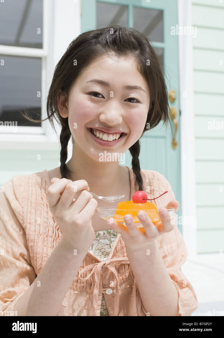 Girl eating jelly outside Stock Photo - Alamy