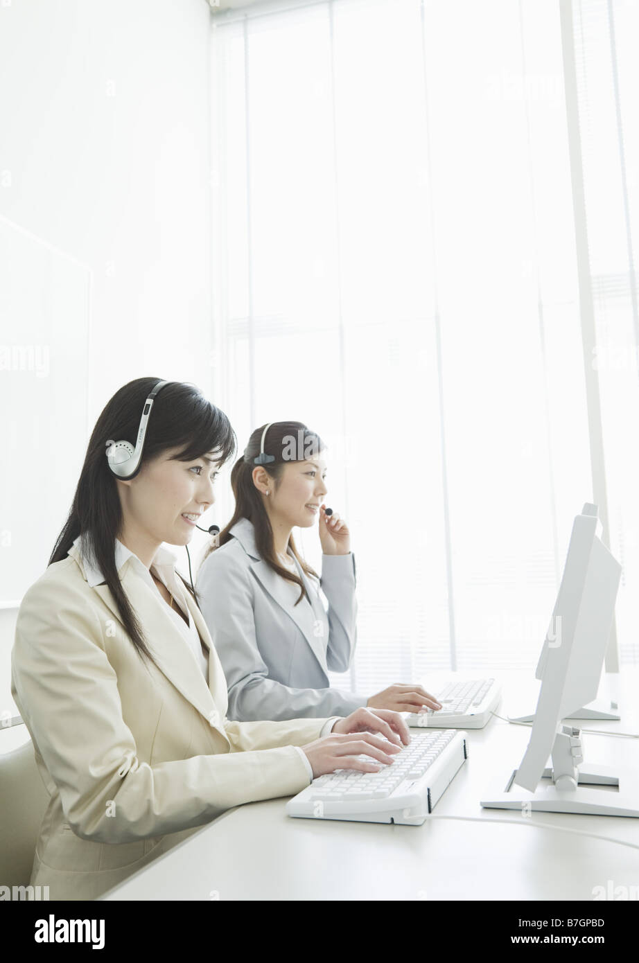 Operators wearing headphones in the office Stock Photo - Alamy