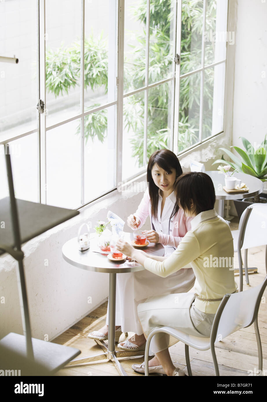 Young women having coffee break Stock Photo - Alamy