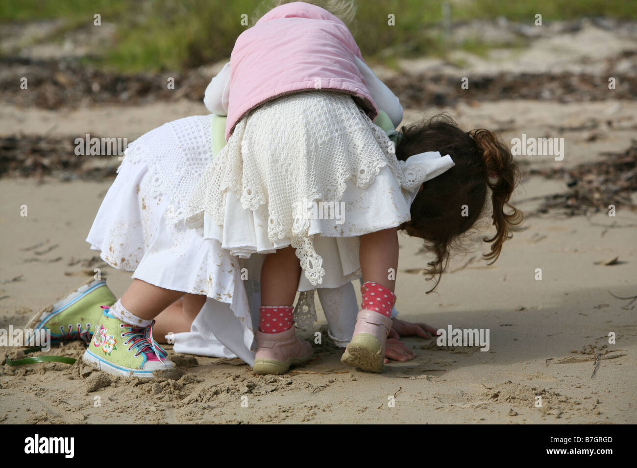 two young girls play together on a sydney beach Stock Photo - Alamy