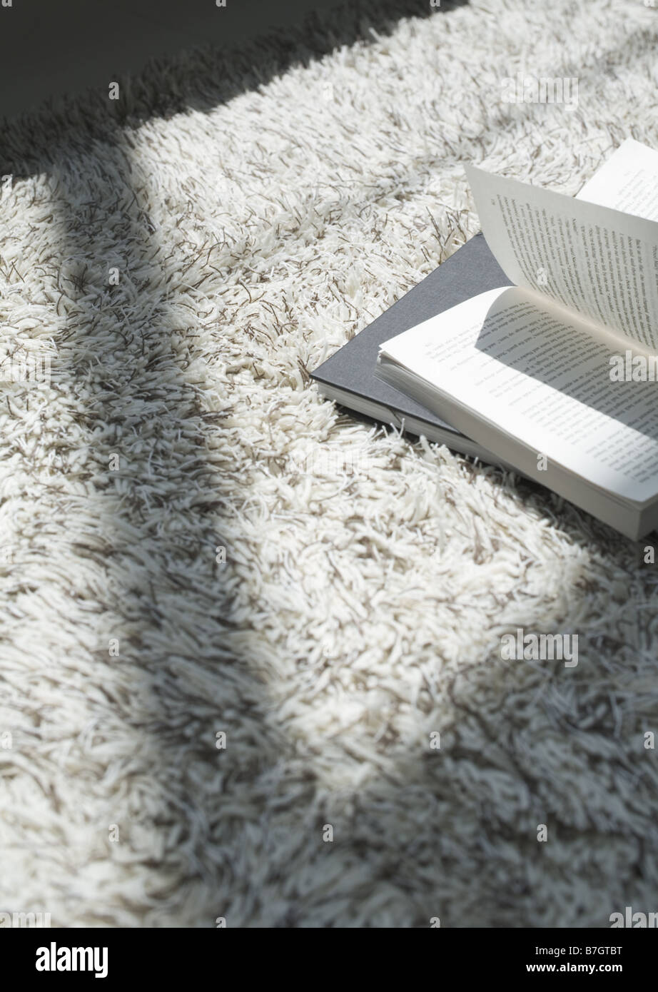 Book on rug Stock Photo - Alamy