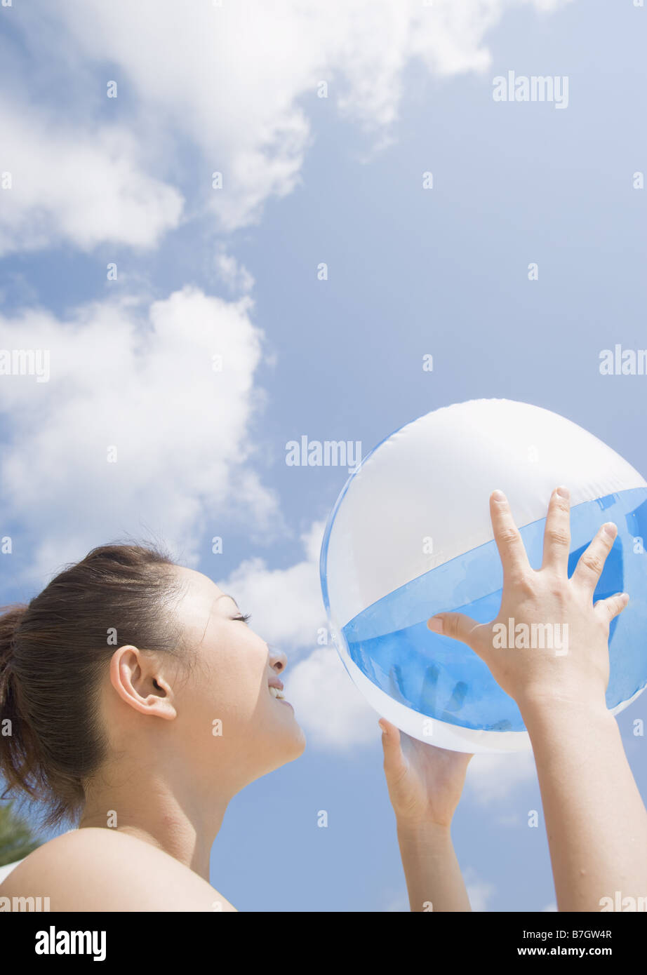 Woman playing with beach ball Stock Photo - Alamy